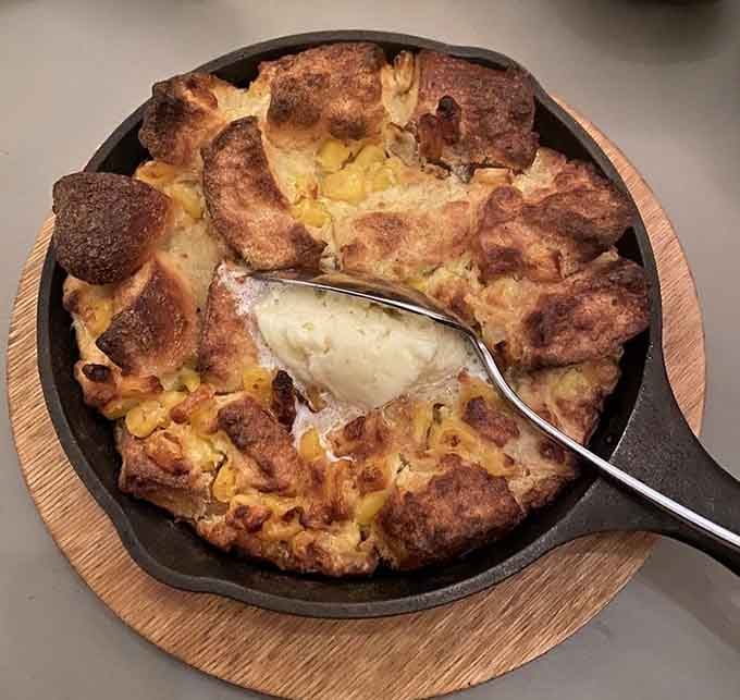 Creamed corn bread pudding in a skillet that redefines what comfort food can actually be.