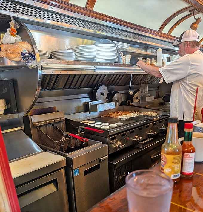 The kitchen staff working their magic in the narrow galley, flipping eggs and hash browns with practiced precision.