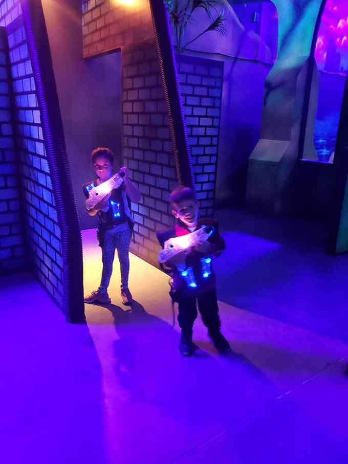 Laser tag warriors emerge from purple-lit corridors looking like tiny action heroes on important classified missions.