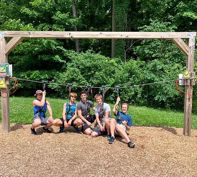 Successful teams celebrate together after conquering challenges that seemed impossible from the safety of solid ground.