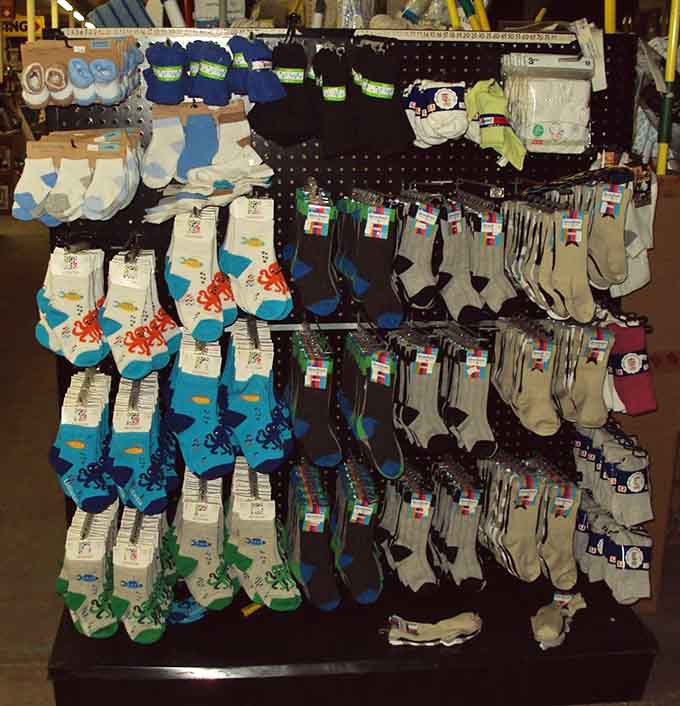 Sock displays organized by pattern and purpose, because everyone needs fresh footwear without paying premium.