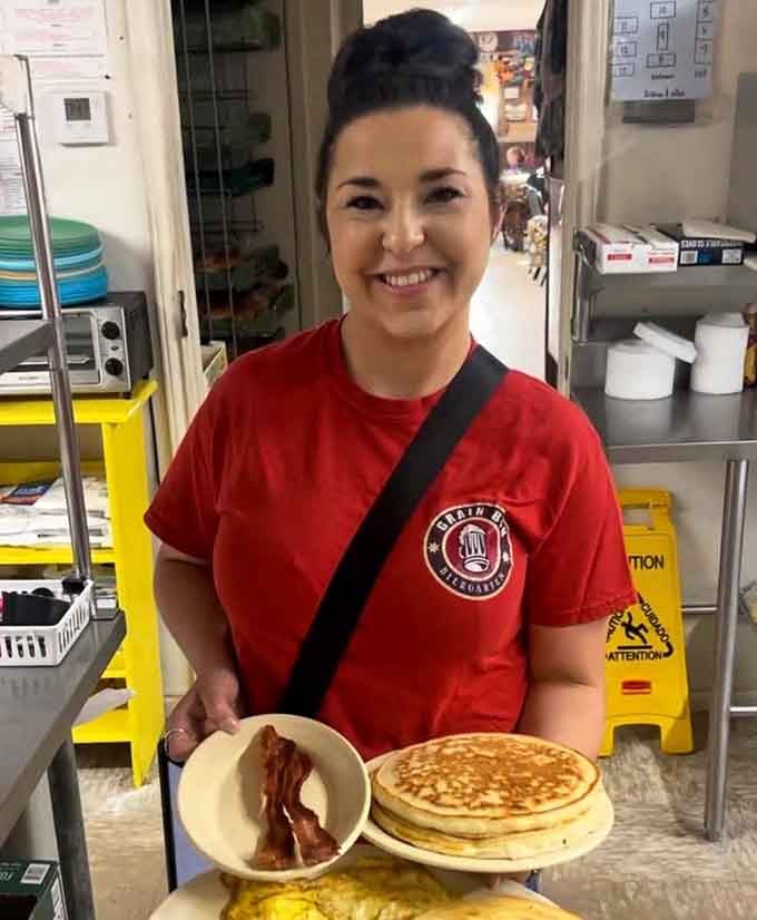 Smiling staff serving up pancakes and bacon, proof that happiness is contagious when food is this good.