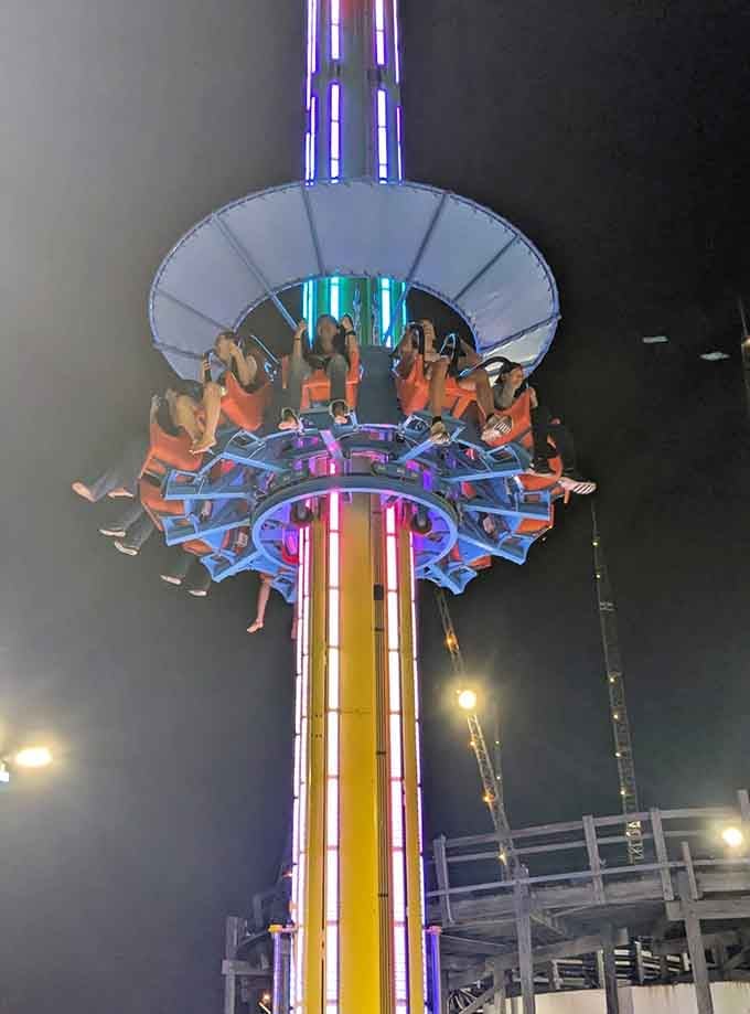 The illuminated park at dusk transforms into a magical landscape where adventure glows in technicolor brilliance.