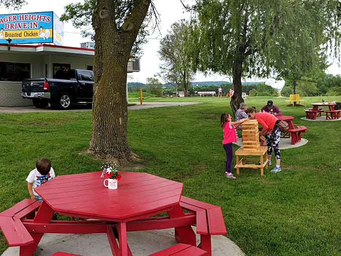 Families playing games on the lawn while waiting for their order is exactly what drive-ins were meant for.