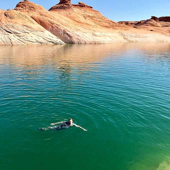 Taking a refreshing dip in turquoise waters that shimmer like liquid gemstones under Arizona sun.