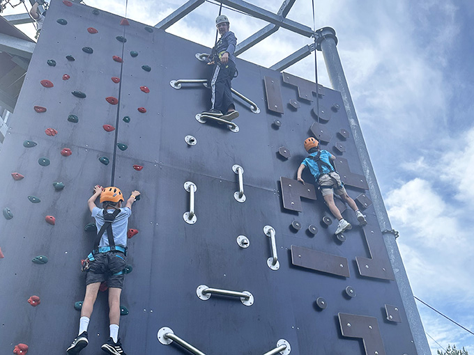 The climbing wall where gravity becomes your frenemy and upper body strength suddenly matters again.