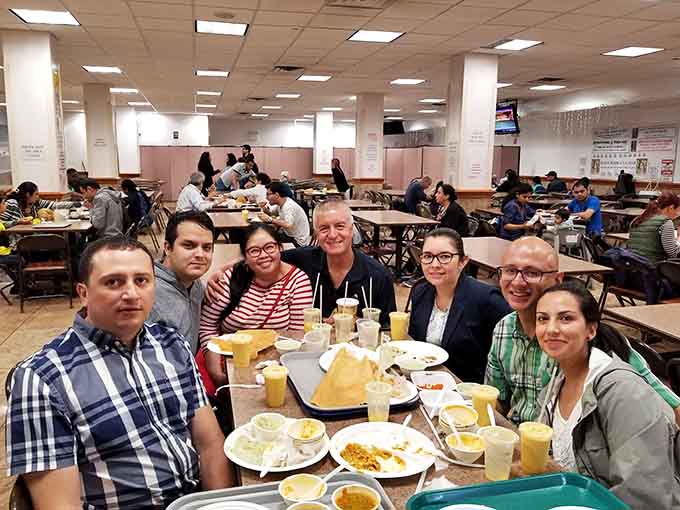 Happy faces around shared meals prove that great food creates universal joy, regardless of where you're from or what you know.