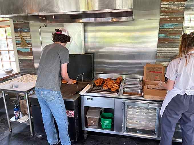 Fresh donuts emerging from the fryer, because watching the magic happen makes them taste even better somehow.