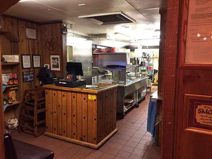 The open kitchen with its gleaming smoker and wood accents shows this crew has nothing to hide from diners.