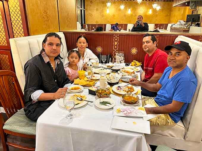 Happy diners enjoying a family meal, which is exactly what happens when everyone agrees on the restaurant choice.