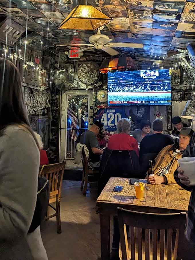 Mismatched seating under license plate ceilings creates organized chaos that somehow feels exactly right here.