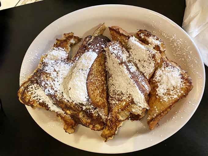 French toast dusted with powdered sugar looks like it just stepped out of a breakfast daydream into delicious reality.