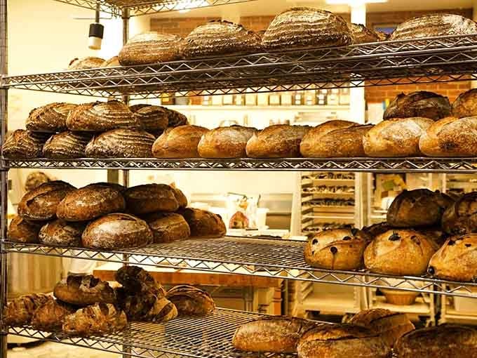 Racks of freshly baked sourdough loaves cooling on wire shelves look like the promised land for anyone who loves real bread.