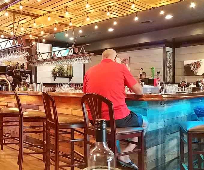 The bar area with its modern blue accents offers the perfect spot for a pre-dinner cocktail.
