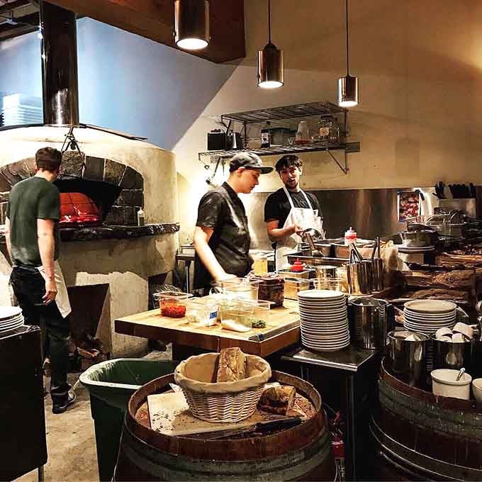 Behind that wood-fired oven, magic happens daily in the form of perfectly charred pizza crusts.