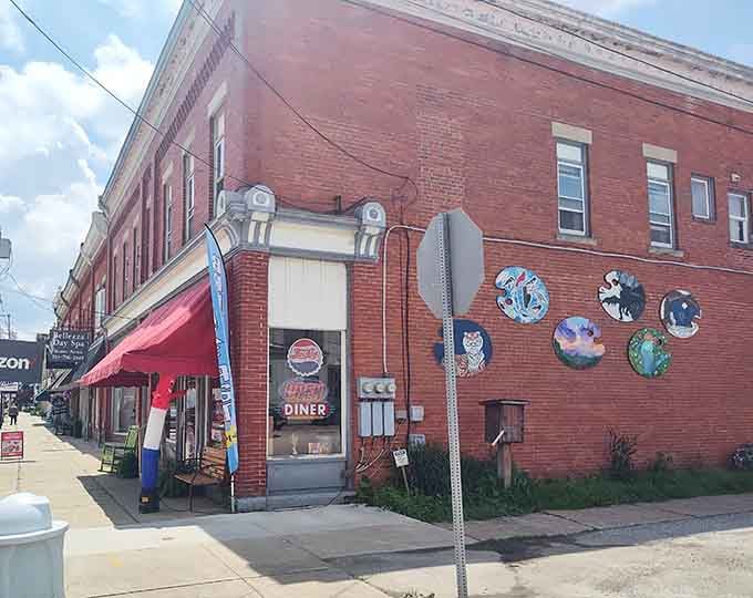 Colorful murals on the brick exterior hint at the personality and warmth waiting inside this corner spot.