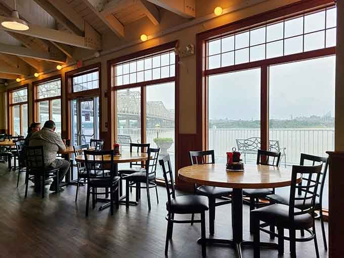 Floor-to-ceiling windows frame river views so stunning you might forget what you ordered until it arrives.