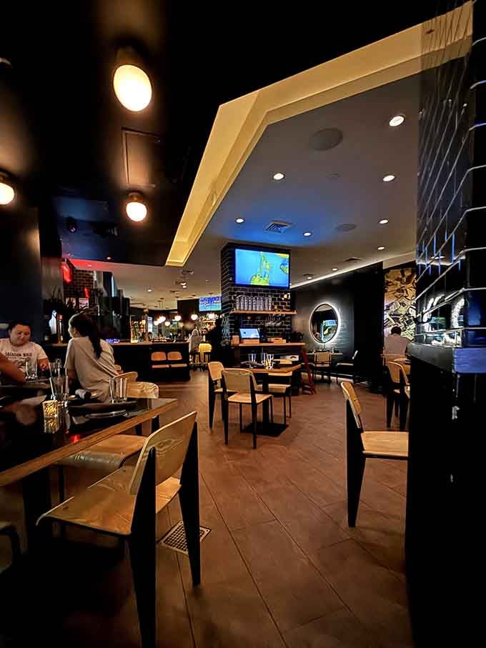 Evening ambiance transforms the dining room into an intimate space where conversations flow as smoothly as the cocktails from that bar.
