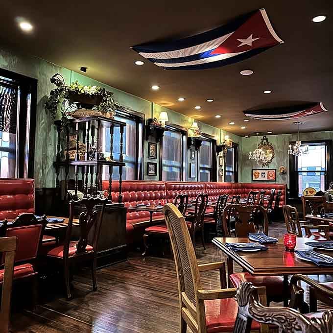 Red leather booths and Cuban flags create the kind of cozy atmosphere where time slows down deliciously.