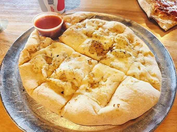 Cheese bread cut into shareable pieces, though sharing is entirely optional when faced with this golden temptation.