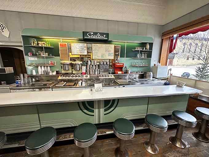 That gleaming Sealtest counter with chrome stools is where magic happens, one handcrafted soda at a time, no shortcuts allowed.