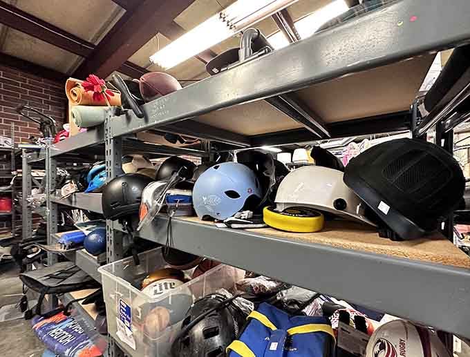 Sports helmets line industrial shelving like a rainbow of protective gear for every athletic pursuit imaginable.