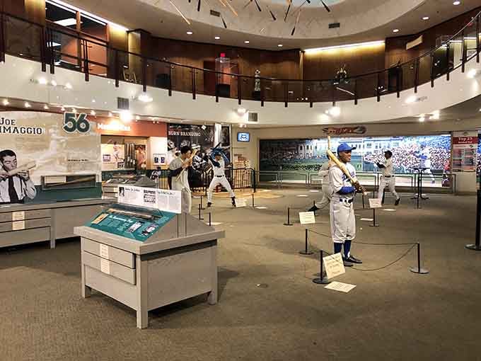 Life-size player statues frozen mid-swing remind visitors that behind every great bat is someone who knew exactly how to use it.