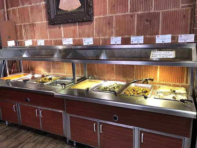 The buffet line stretches out like a spice-scented promise, each warming tray holding another reason to loosen your belt.