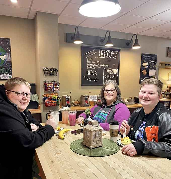 Three generations sharing laughs over lattes, proving that good coffee creates the best family memories together.