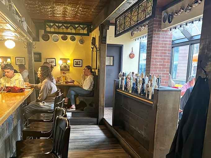 Warm lighting and German memorabilia create cozy corners where strangers become friends over shared plates and laughter.