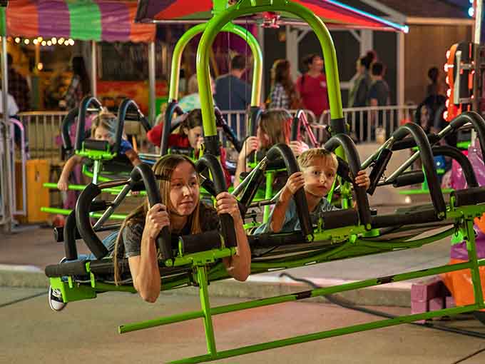 The Sky Flyer swings glow against the evening sky, offering thrills that'll make your stomach drop faster than Newton's apple.