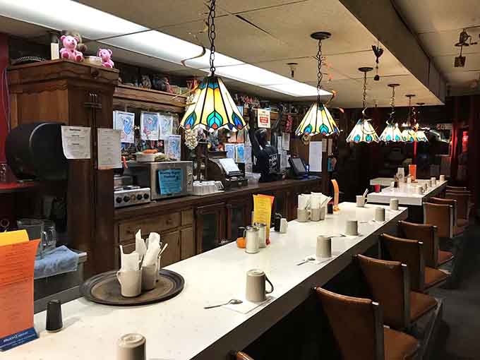 The counter stretches long and inviting, offering front-row seats to the breakfast theater happening behind the kitchen line.