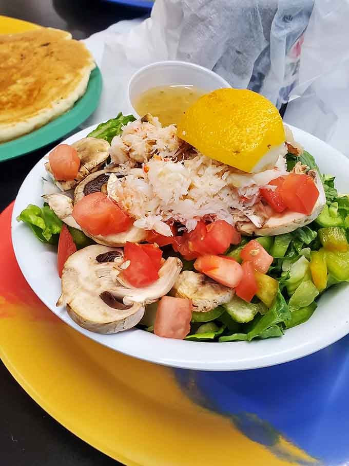 Fresh crab meat piled on crisp greens proves that not everything here requires structural support to eat properly.