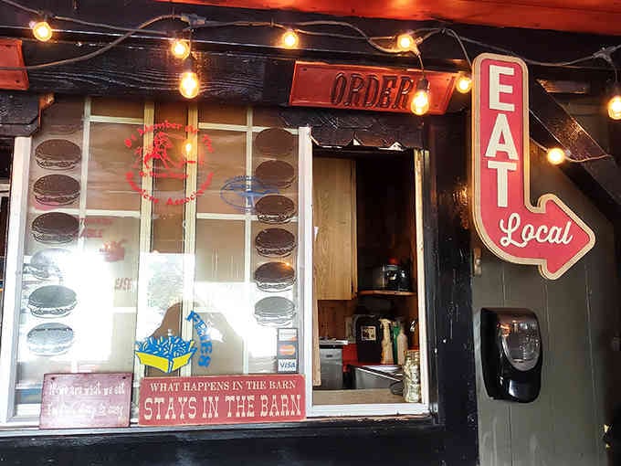 String lights and neon glow above the order window, creating ambiance that says "Eat Local" louder than any marketing campaign.