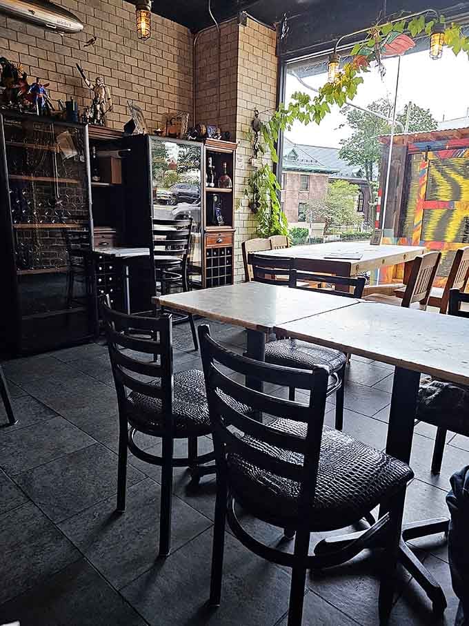 Mismatched chairs and simple tables create the kind of unpretentious comfort that makes strangers feel like family instantly.