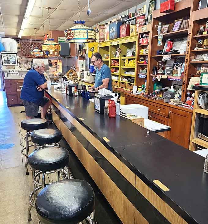 The classic soda fountain counter with swivel stools invites you to sit, spin, and sip like it's 1955 again.