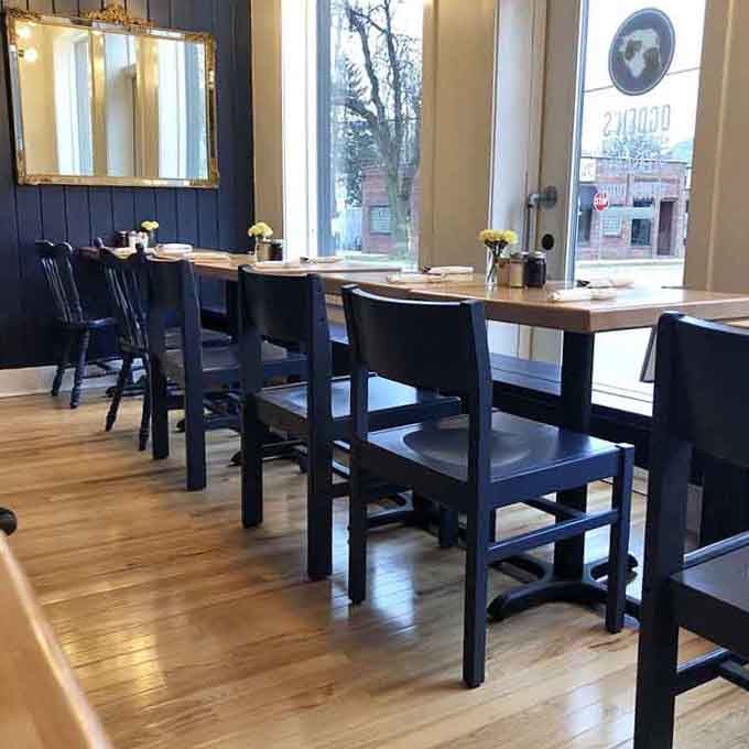 Simple wooden tables by sunny windows create the perfect spot for lingering over coffee and pretending you have nowhere else to be.