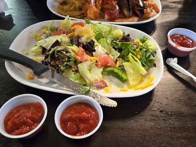 Fresh salad bar proving that even buffet champions need their vegetables before diving into round three of desserts.
