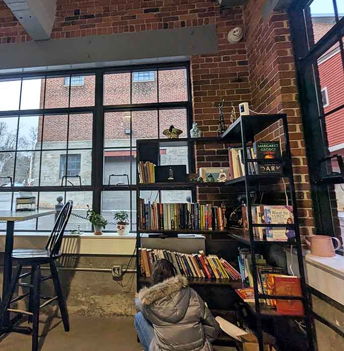 A bookshelf by the window suggests someone understands that caf&eacute;s should nourish both body and mind equally.