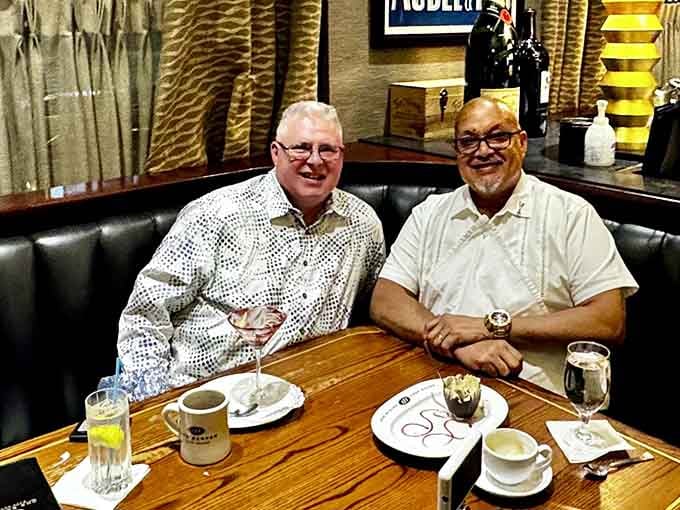 Two happy diners enjoying their meal, proof that great food brings people together over coffee and conversation.
