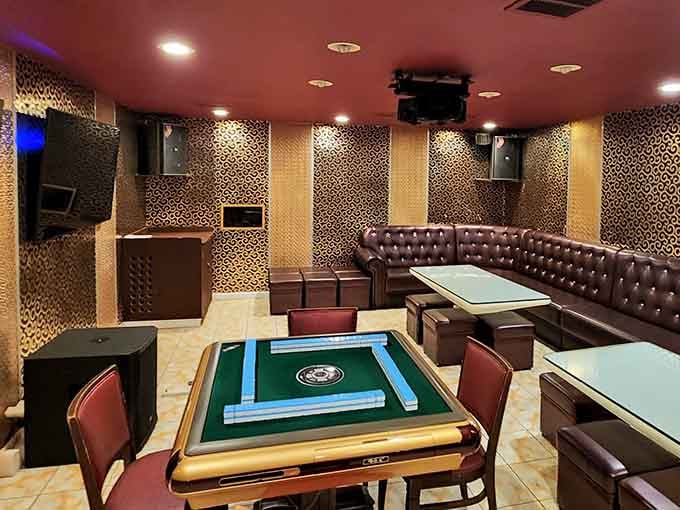 A mahjong table sits ready for players in the entertainment area, adding another layer of fun to this multifaceted venue.