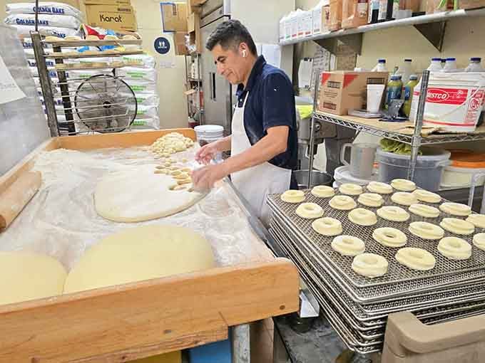 Behind the scenes where the magic happens, one perfectly shaped donut at a time, before dawn breaks.