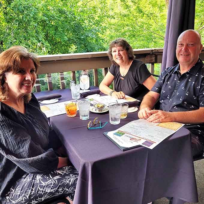 Happy diners on the patio prove that great food tastes even better with good company.