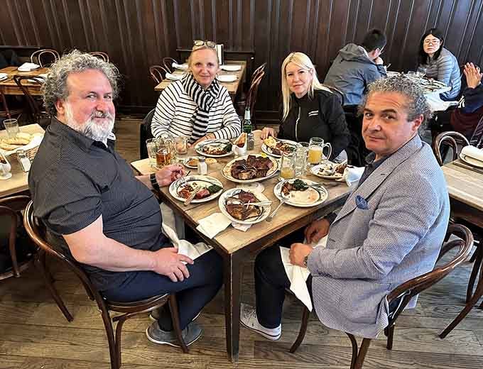 Happy diners mid-feast, experiencing what generations before them have known: this place delivers every time.