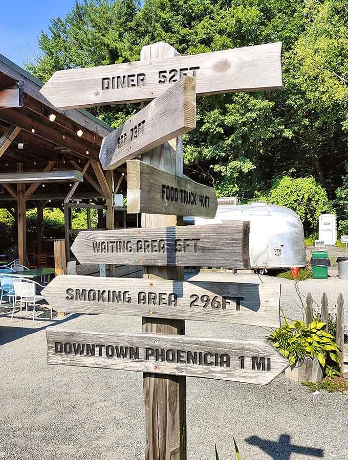 The handmade directional sign adds whimsy and charm, pointing you toward the diner, food truck, and downtown Phoenicia adventures ahead.