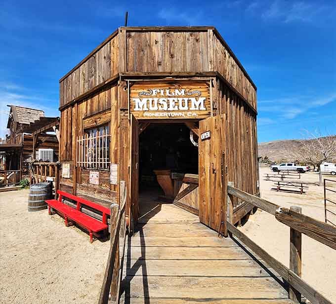 That bright red bench welcomes visitors to explore the film history preserved inside this charming wooden museum building.
