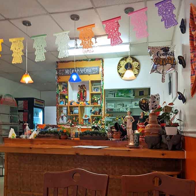 The order counter decorated with papel picado and Mexican pottery sets the stage for authentic flavors to come.