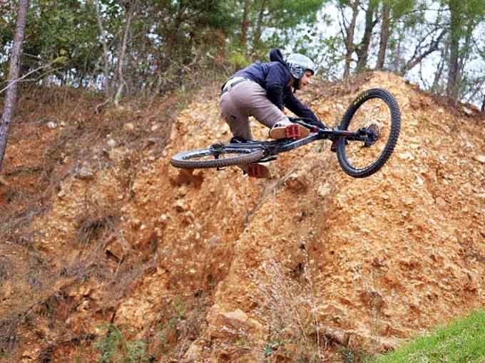 Leaning hard into a leaf-covered descent, this rider shows perfect form while gravity does its magnificent, terrifying work.