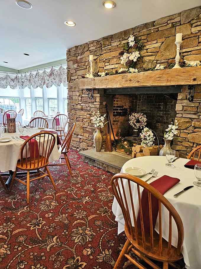 Stone fireplace anchors this cozy dining room where romance and prime rib coexist in harmony.