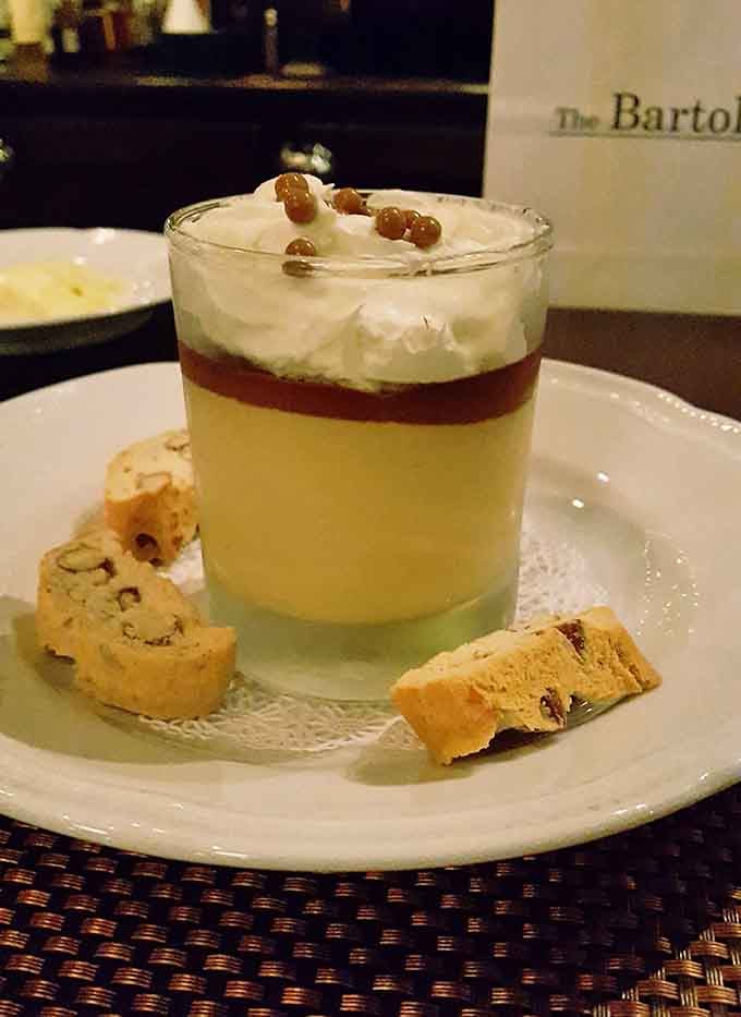 Layered budino dessert with biscotti on the side, sweet enough to satisfy without requiring a nap immediately afterward.